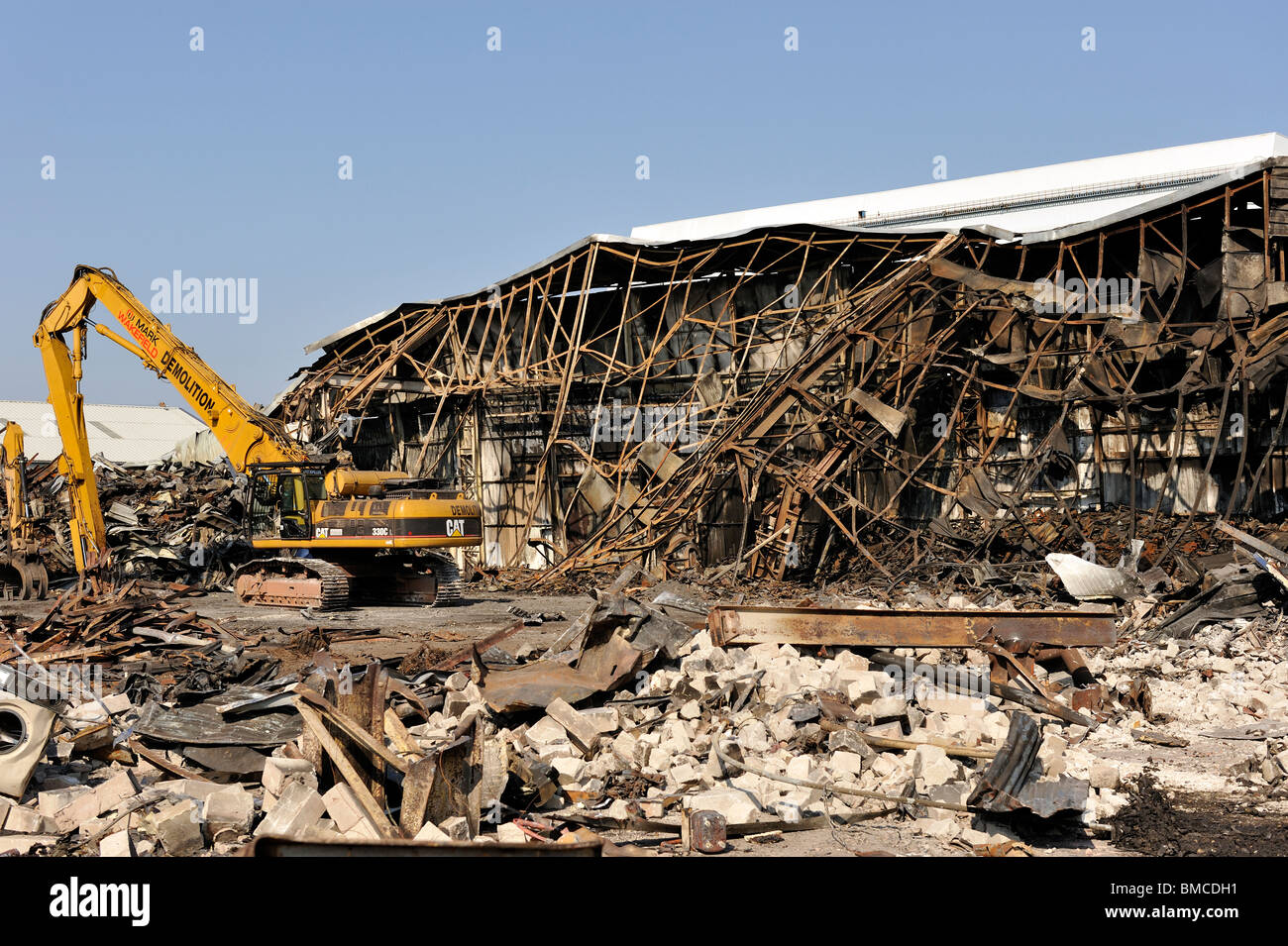 Steel warehouse being demolished after fire Stock Photo - Alamy