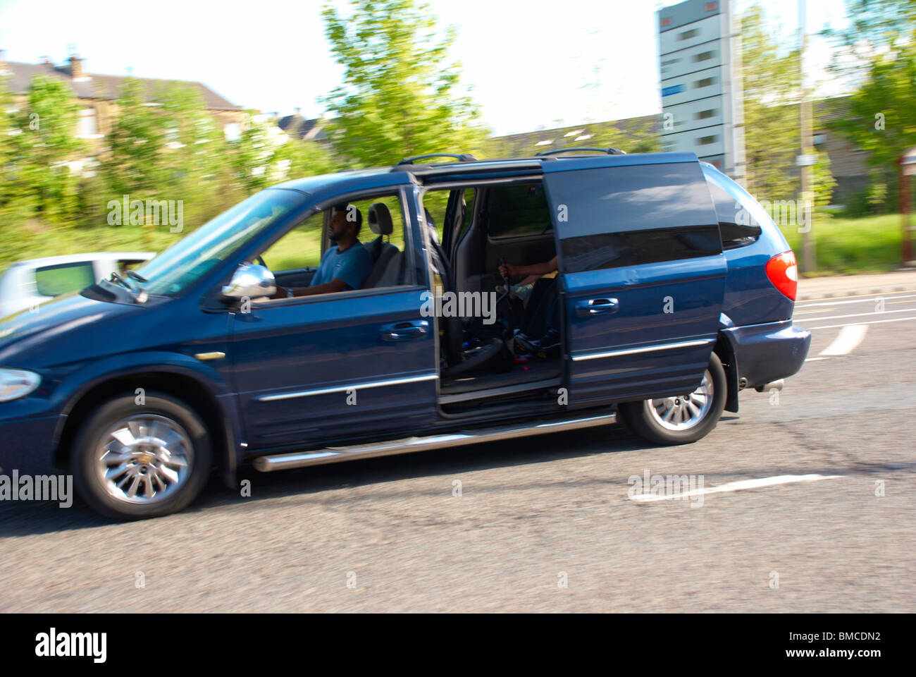 Car cruising around on a sunny day Stock Photo - Alamy