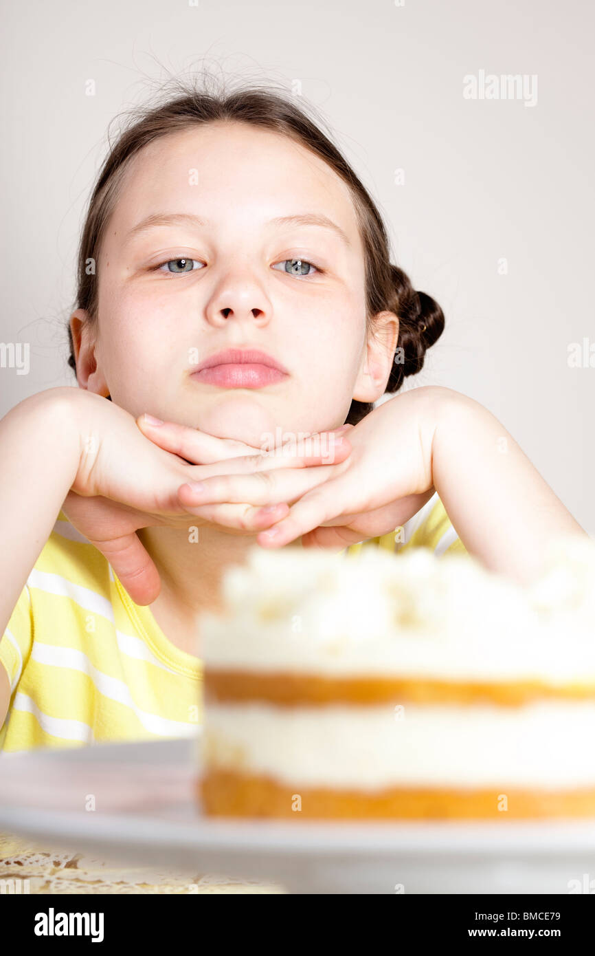 girl looking at cake Stock Photo - Alamy