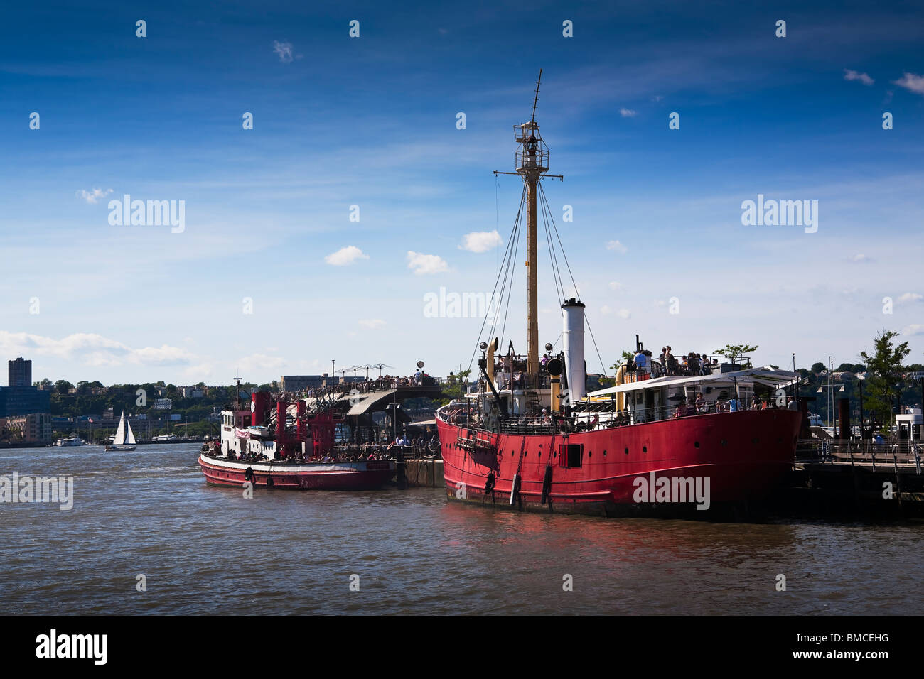 People crowd onto the John J Harvey and Frying Pan ships situated on ...