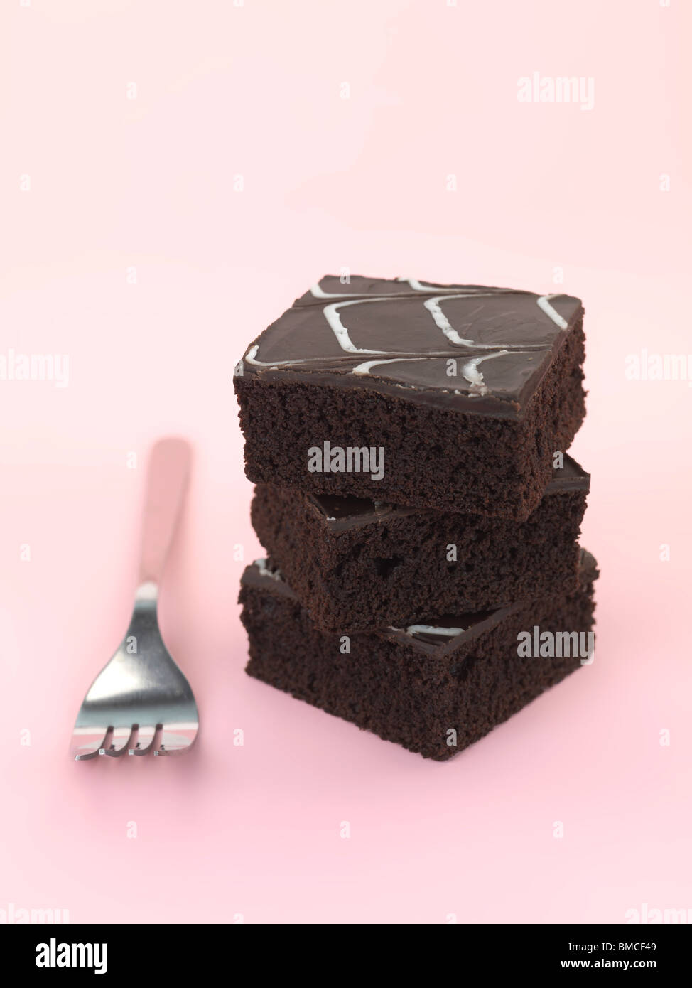 Chocolate mud cake slices isolated against a pink background Stock ...