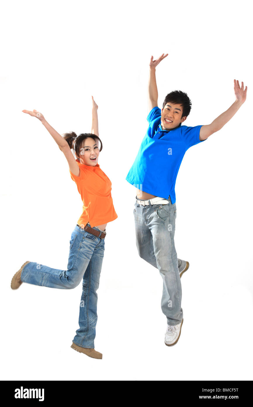 Man and woman jumping for joy Stock Photo - Alamy