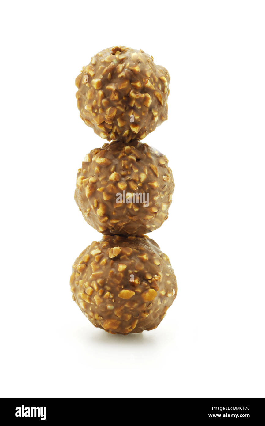 Stack of chocolate nut balls on white background Stock Photo - Alamy