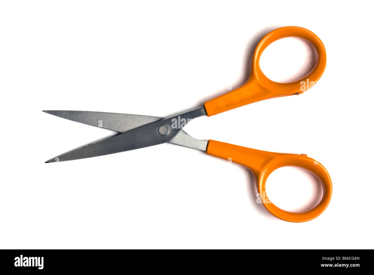 Orange scissors isolated on white background Stock Photo - Alamy