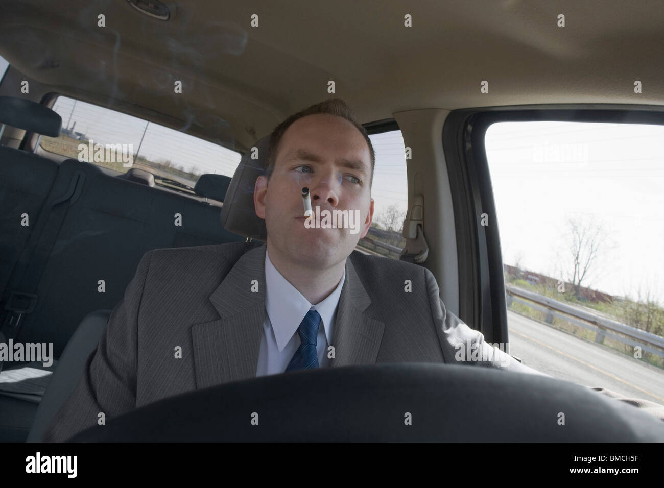 Driver Smoking a Cigarette Stock Photo - Alamy