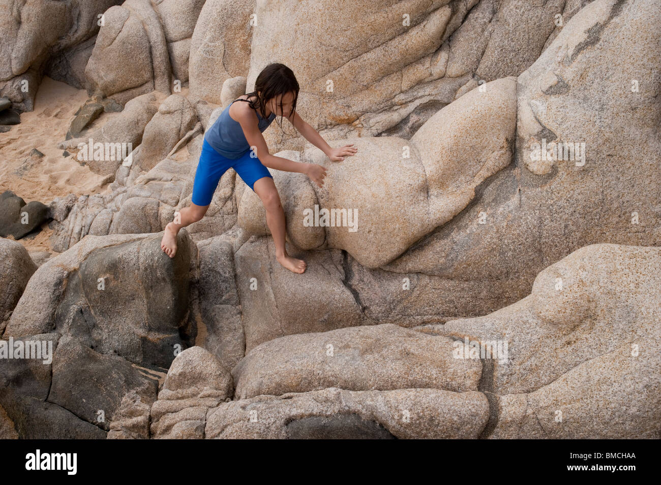 Girl Climbing Over Rocks Stock Photo - Alamy