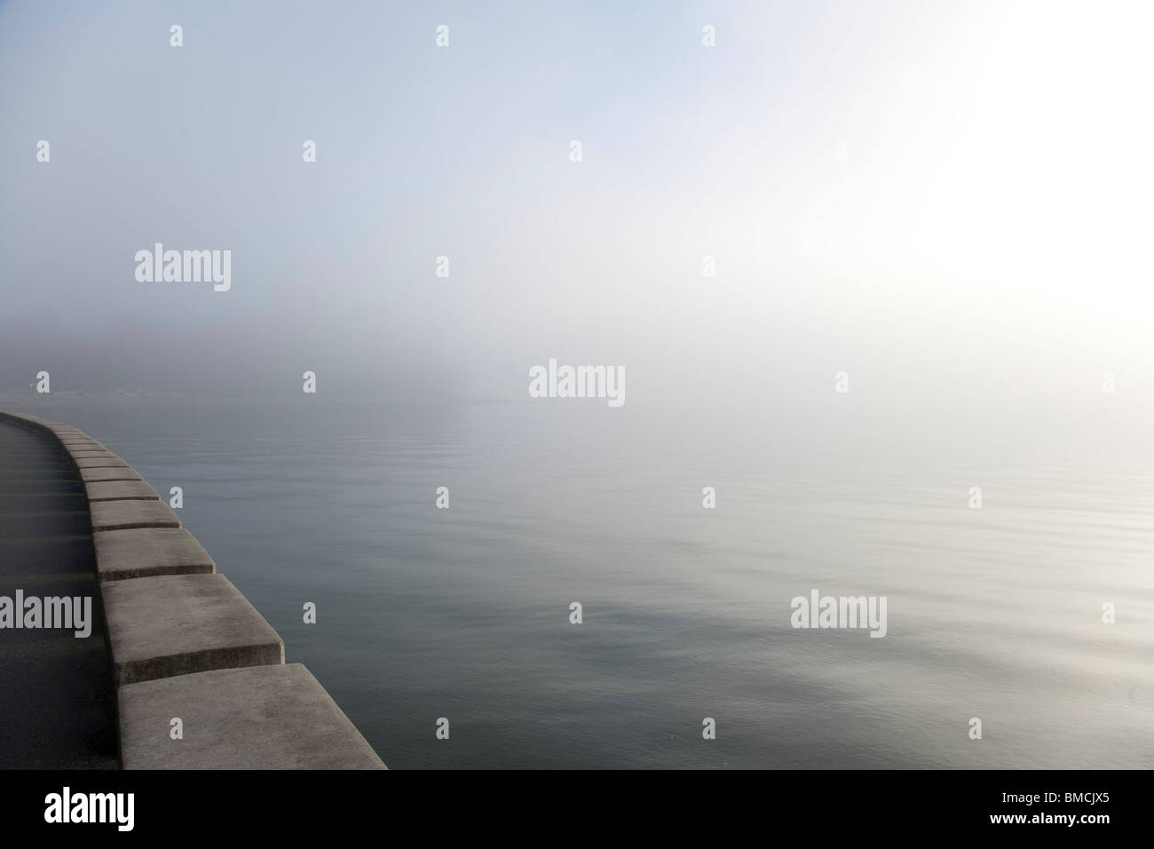Seawall and Fog over Water Stock Photo - Alamy
