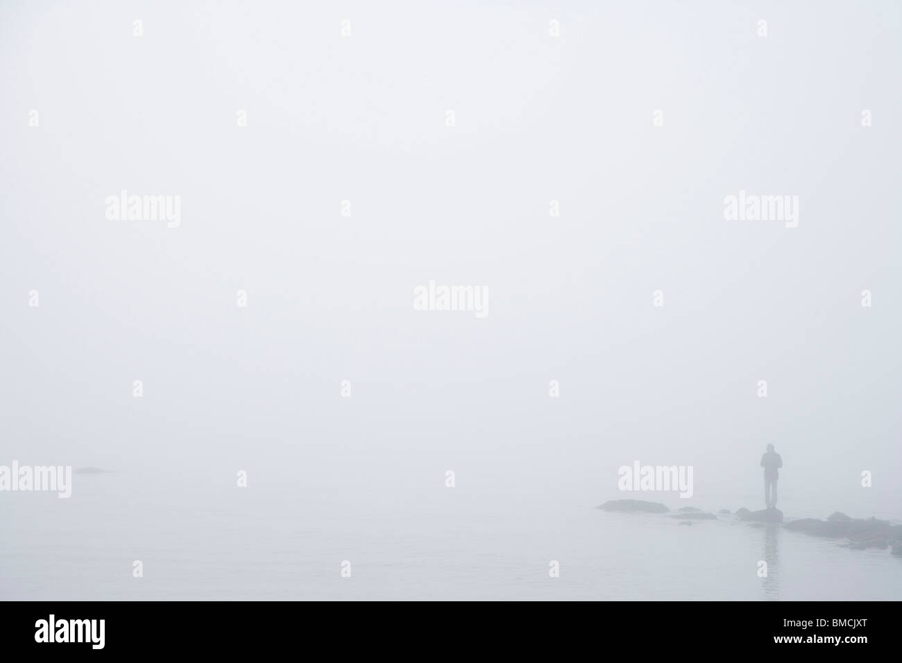 Person on Rocks in Fog Stock Photo - Alamy