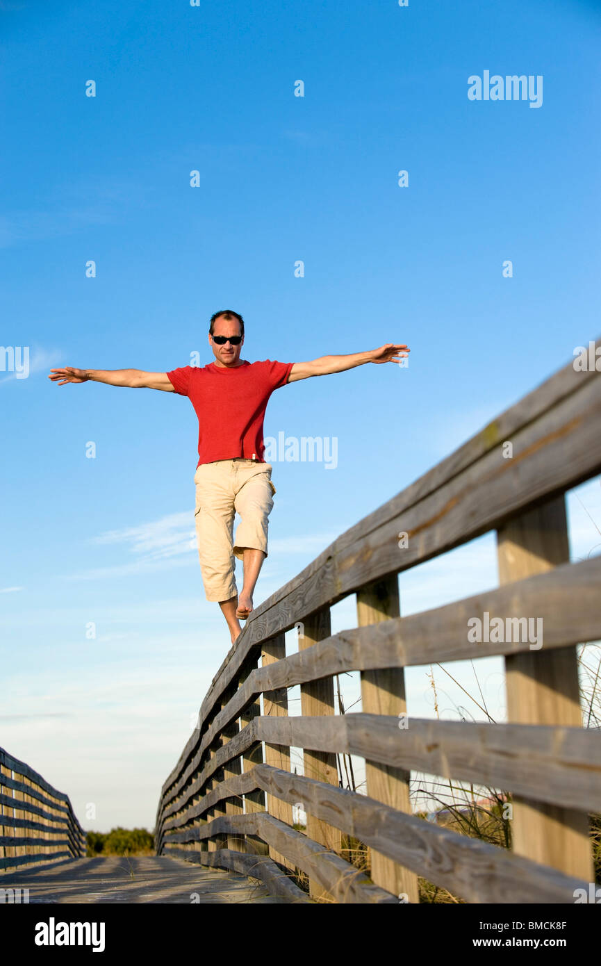 Man Balancing on Wooden Railing, Honeymoon Island, Florida, USA Stock ...