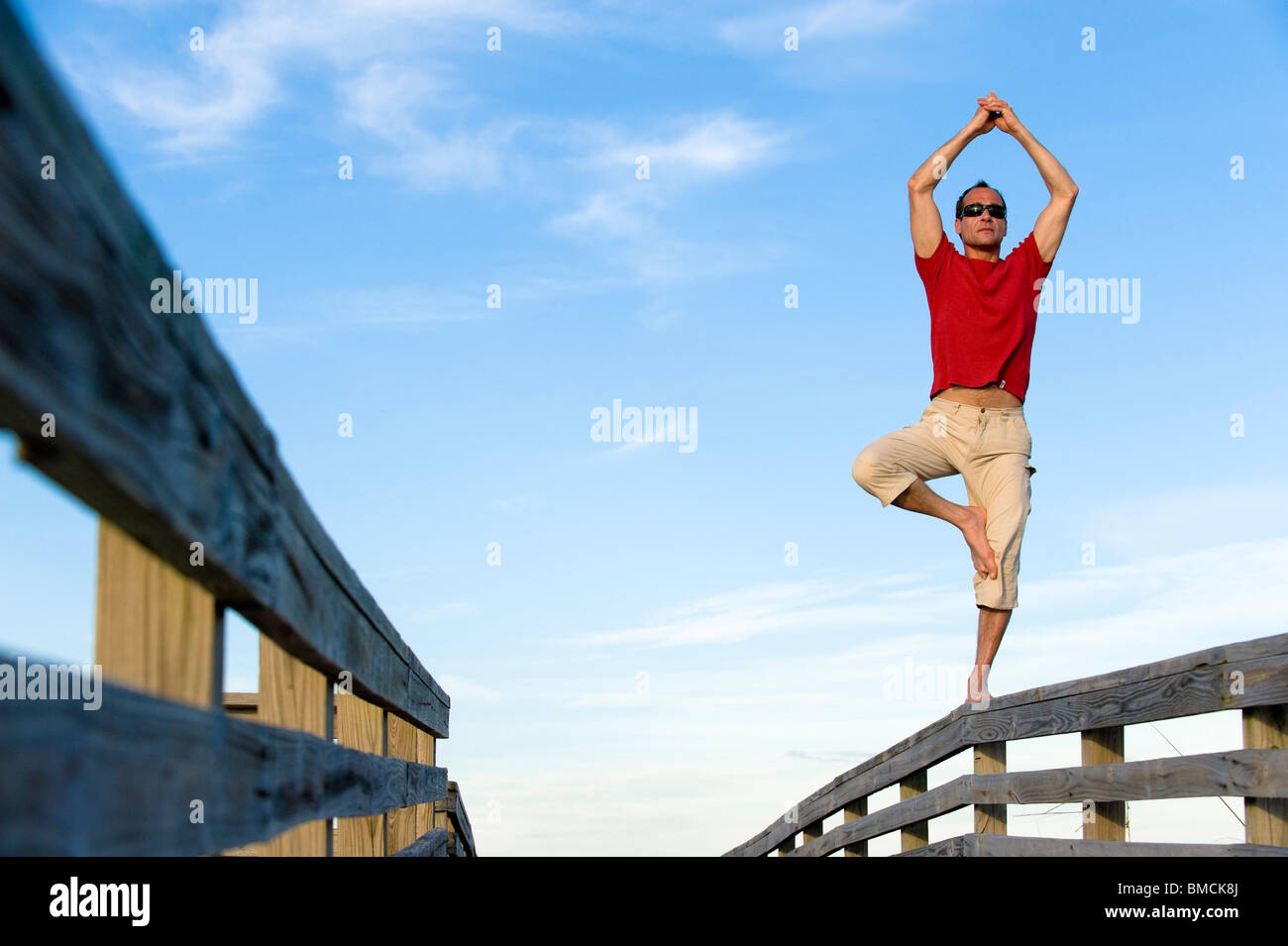 Man Balancing on Wooden Railing, Honeymoon Island, Florida, USA Stock ...