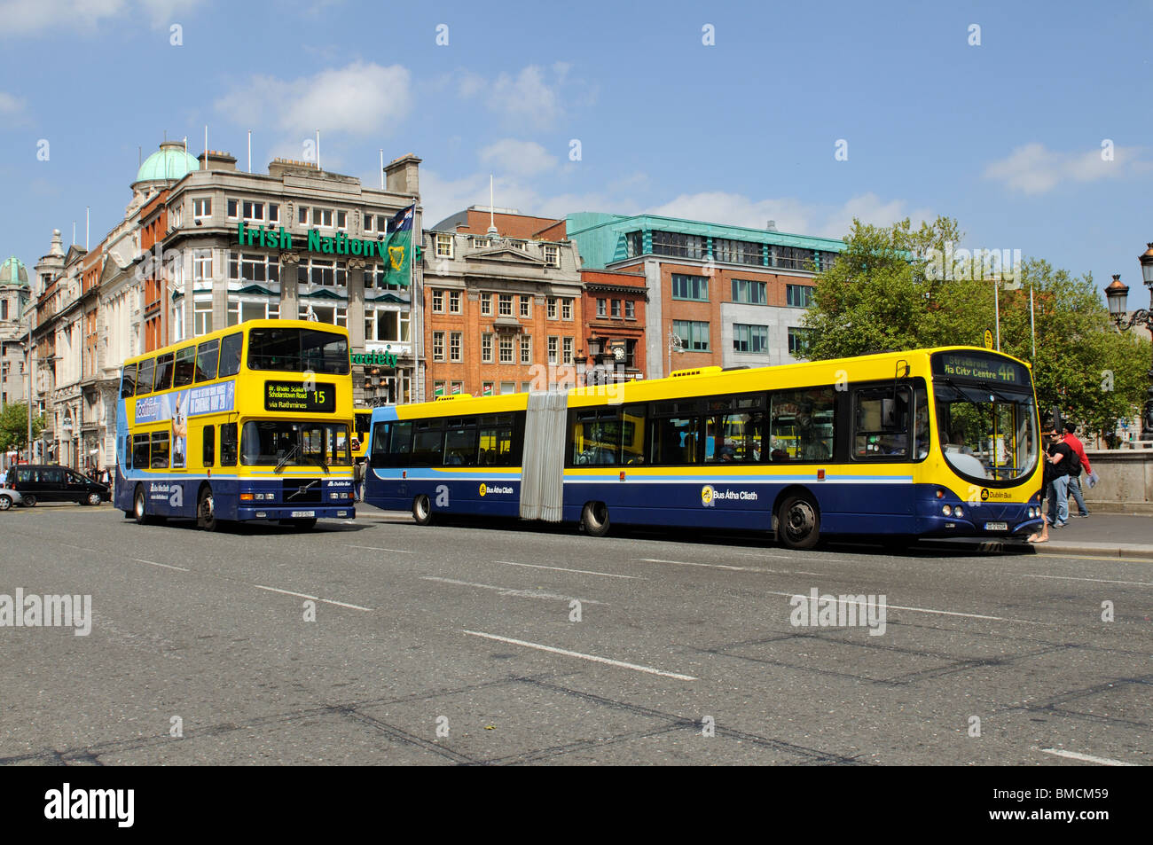 Yellow and Blue painted Dublin buses on O'Connell Bridge Dublin Ireland ...
