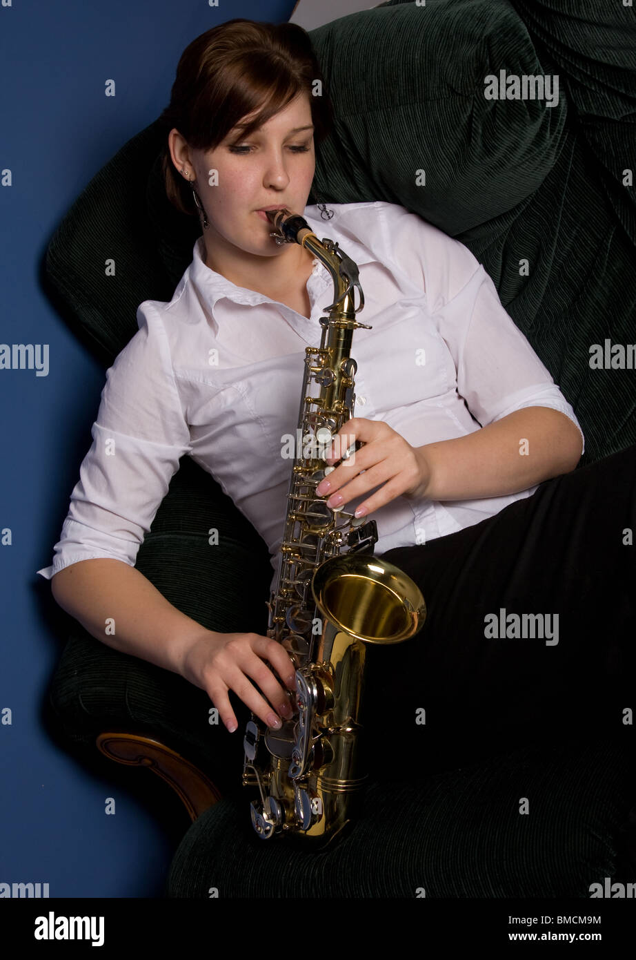 Girl playing saxophone Stock Photo - Alamy