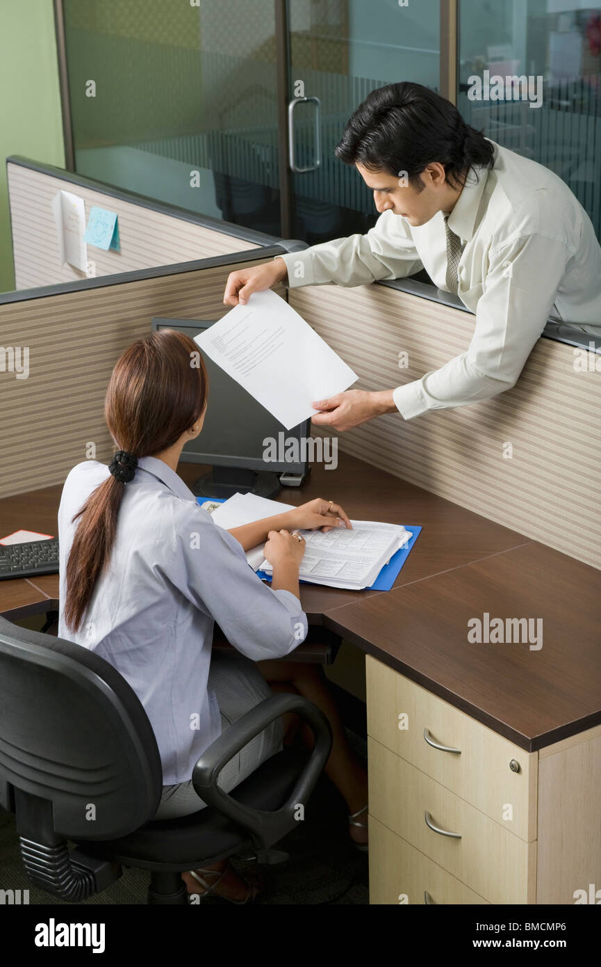 Two business executives discussing a document in an office Stock Photo ...