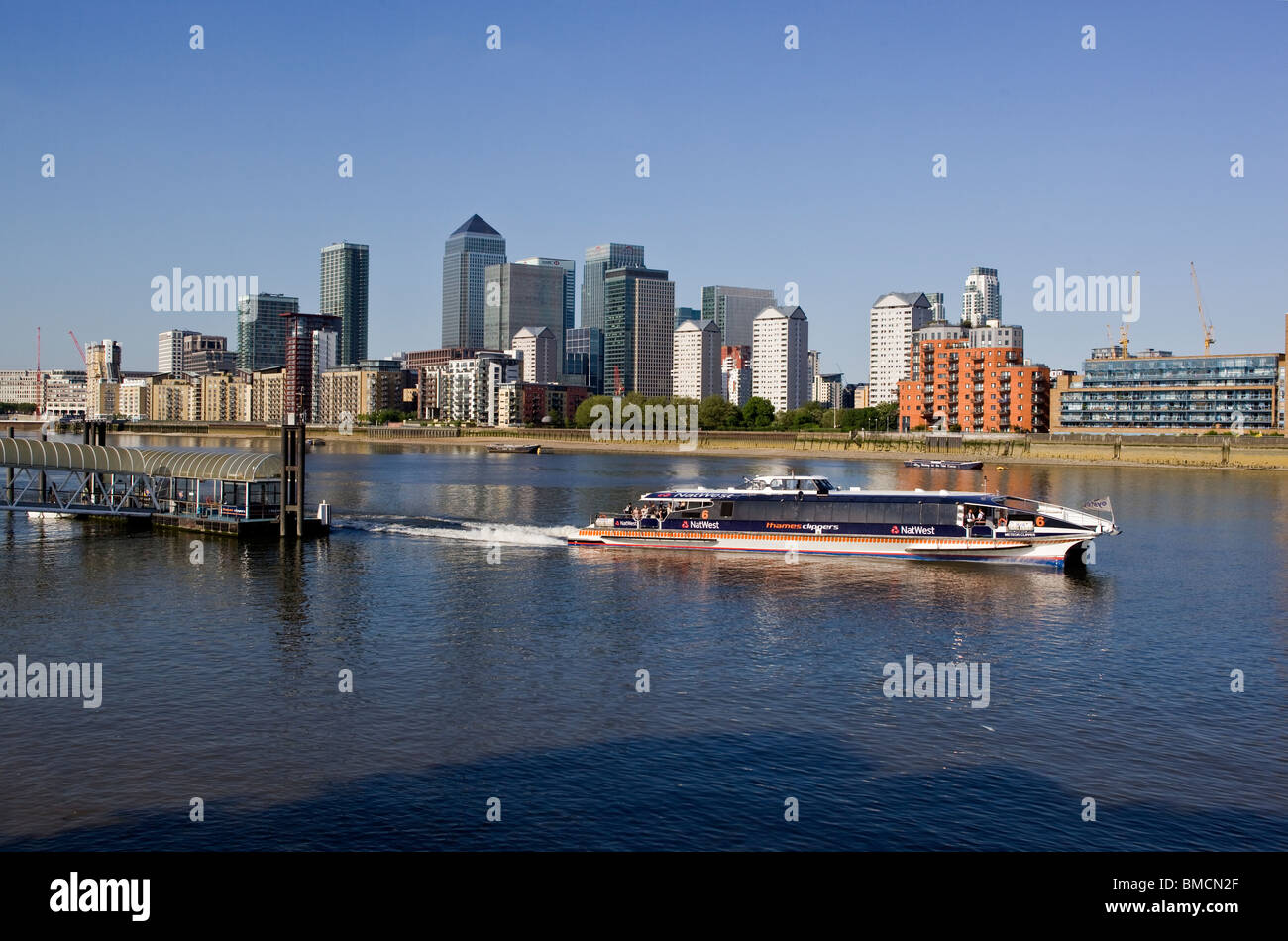 Thames Clipper Riverboat with Canary Wharf in background River Thames ...