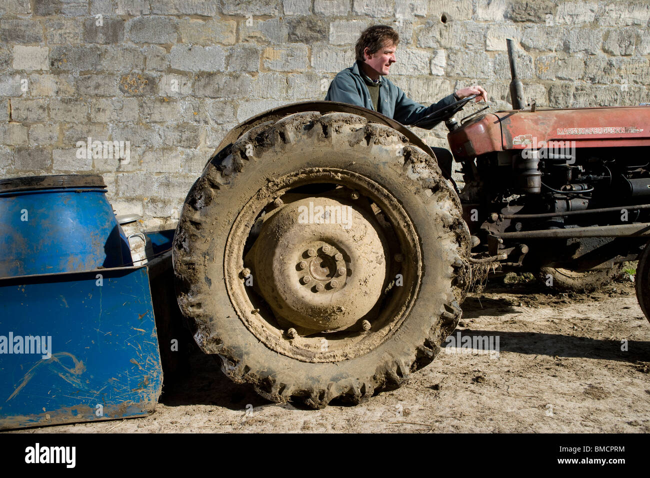 Farmer Jonathan Crump driving his tractor on Standish Park Farm ...