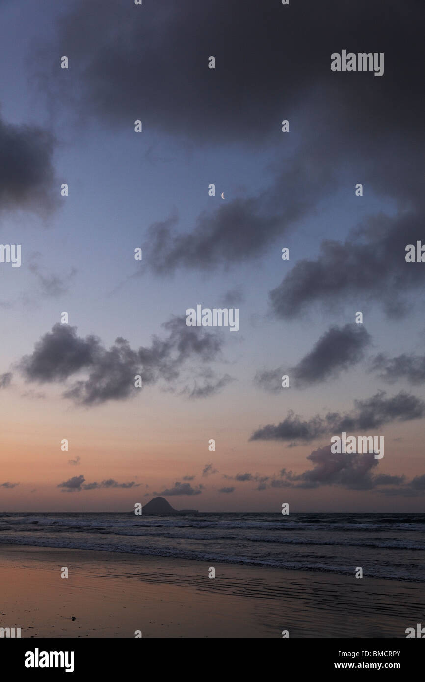 A sunset over Ohope Beach with Whale Island and the moon in the ...