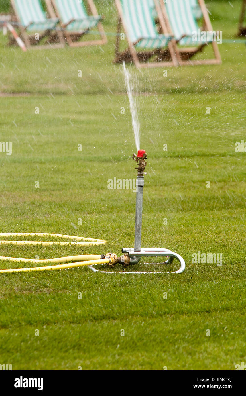 Sprinkler in public park Stock Photo - Alamy