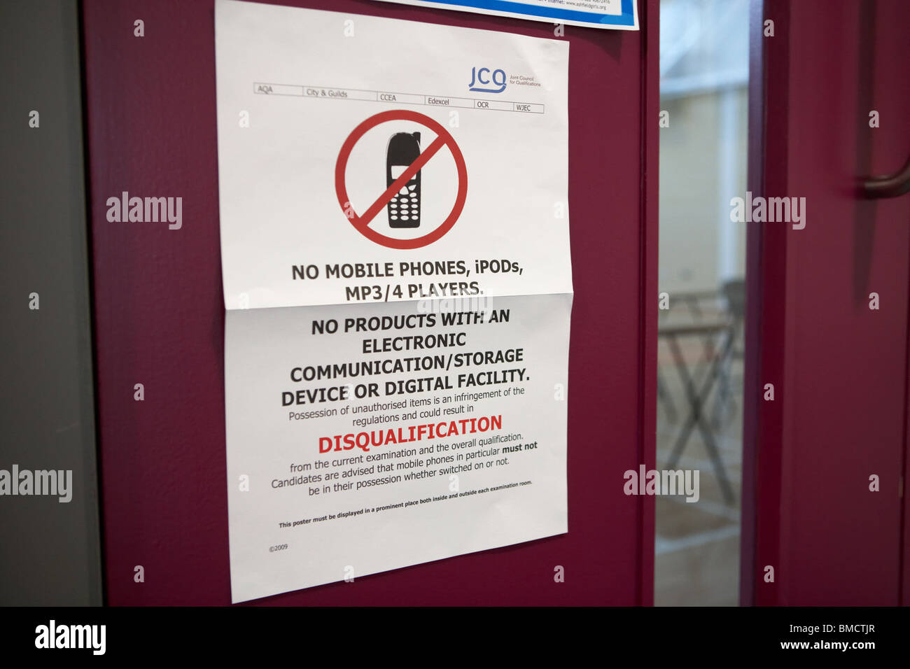 warning notice on the outside of a school exam room door banning mobile ...