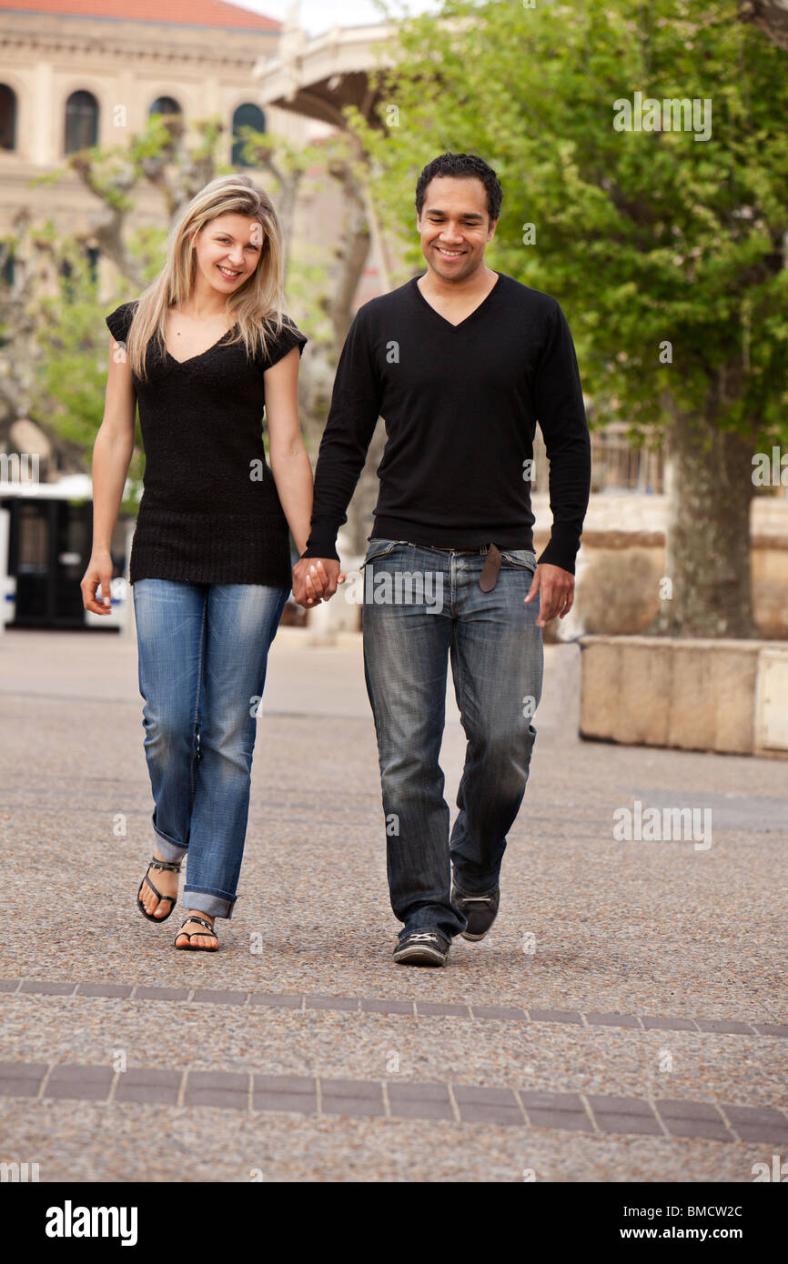 A couple walking outdoors in an urban landscape Stock Photo - Alamy