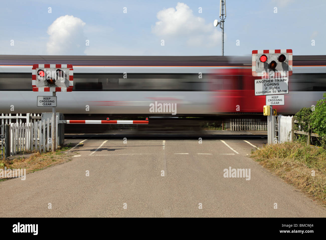 TRAIN AT SPEED OVER ROAD/RAIL CROSSING Stock Photo - Alamy
