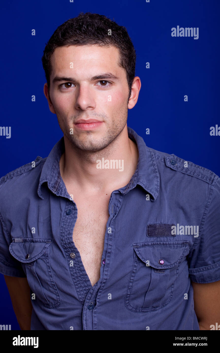 an casual young man portrait over a blue background Stock Photo - Alamy