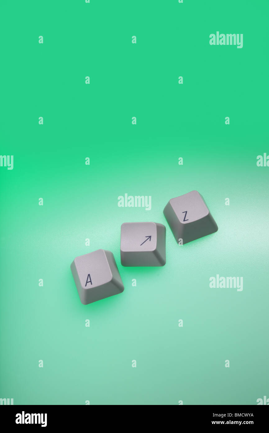 Three separate computer keys, A, arrow and Z, on a graduated green ...