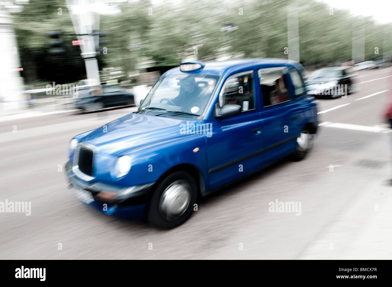 Blue Taxi traveling through London Stock Photo - Alamy