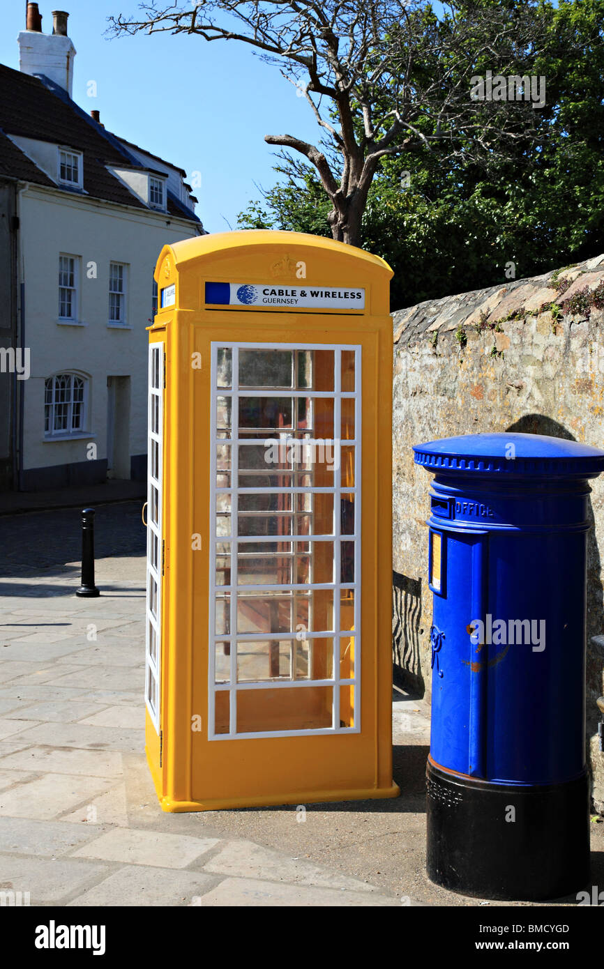 Yellow telephone box and blue letter box on High Street, St. Anne ...