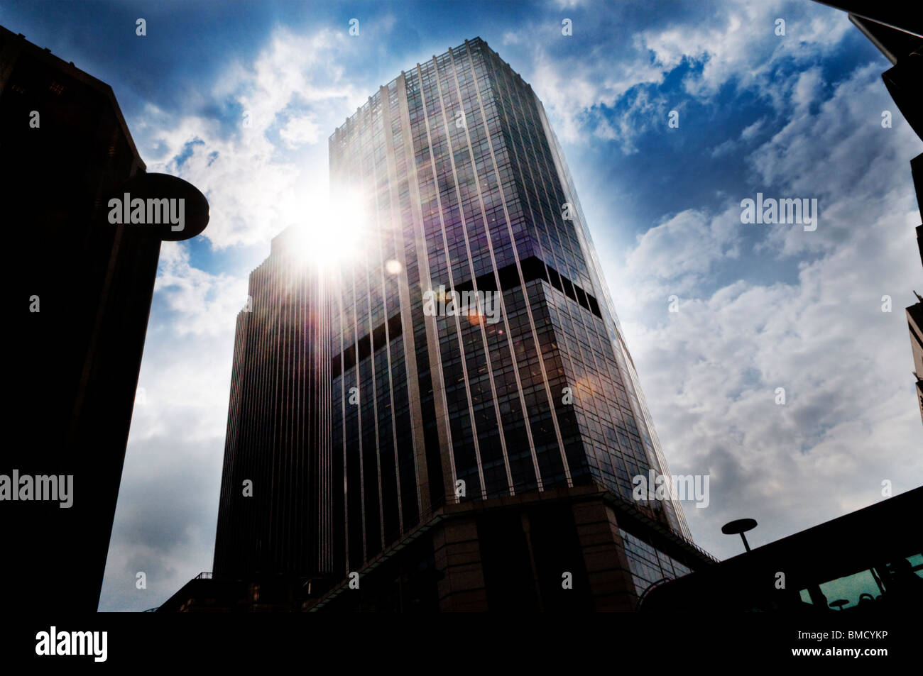 Sun shining behind office building Stock Photo - Alamy