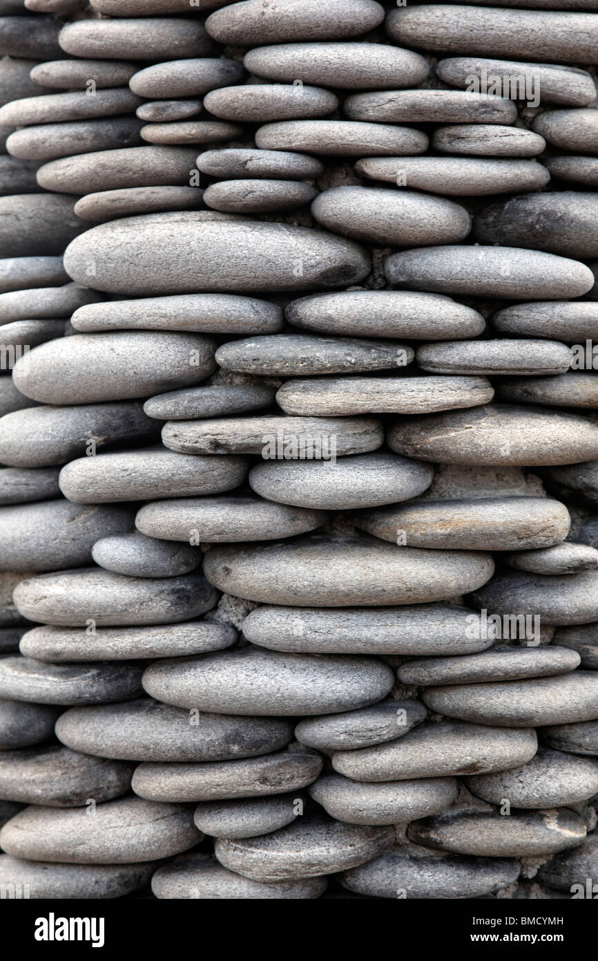 Stacked smooth stones forming a vertical column with an even, layered ...