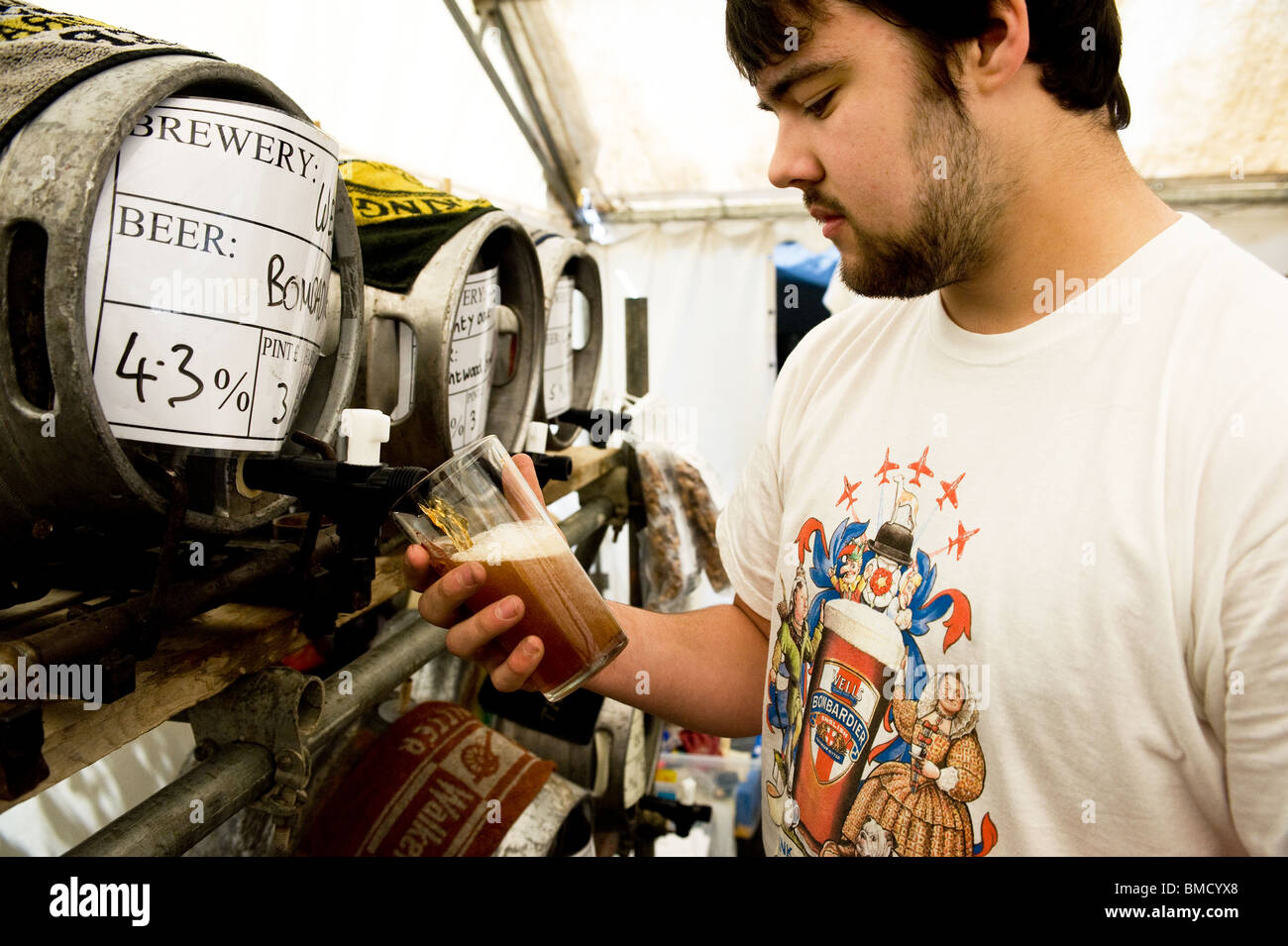 A bar worker pouring a pint of real ale at the Hoop Beer Festival in ...