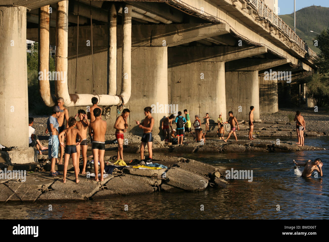 People swimming in a river under the bridge Stock Photo - Alamy