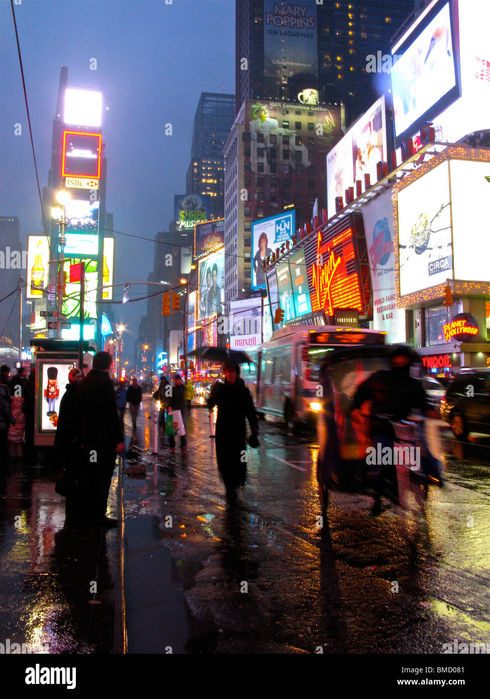 Times Square, New York in the rain at night. The brightly colored neon ...
