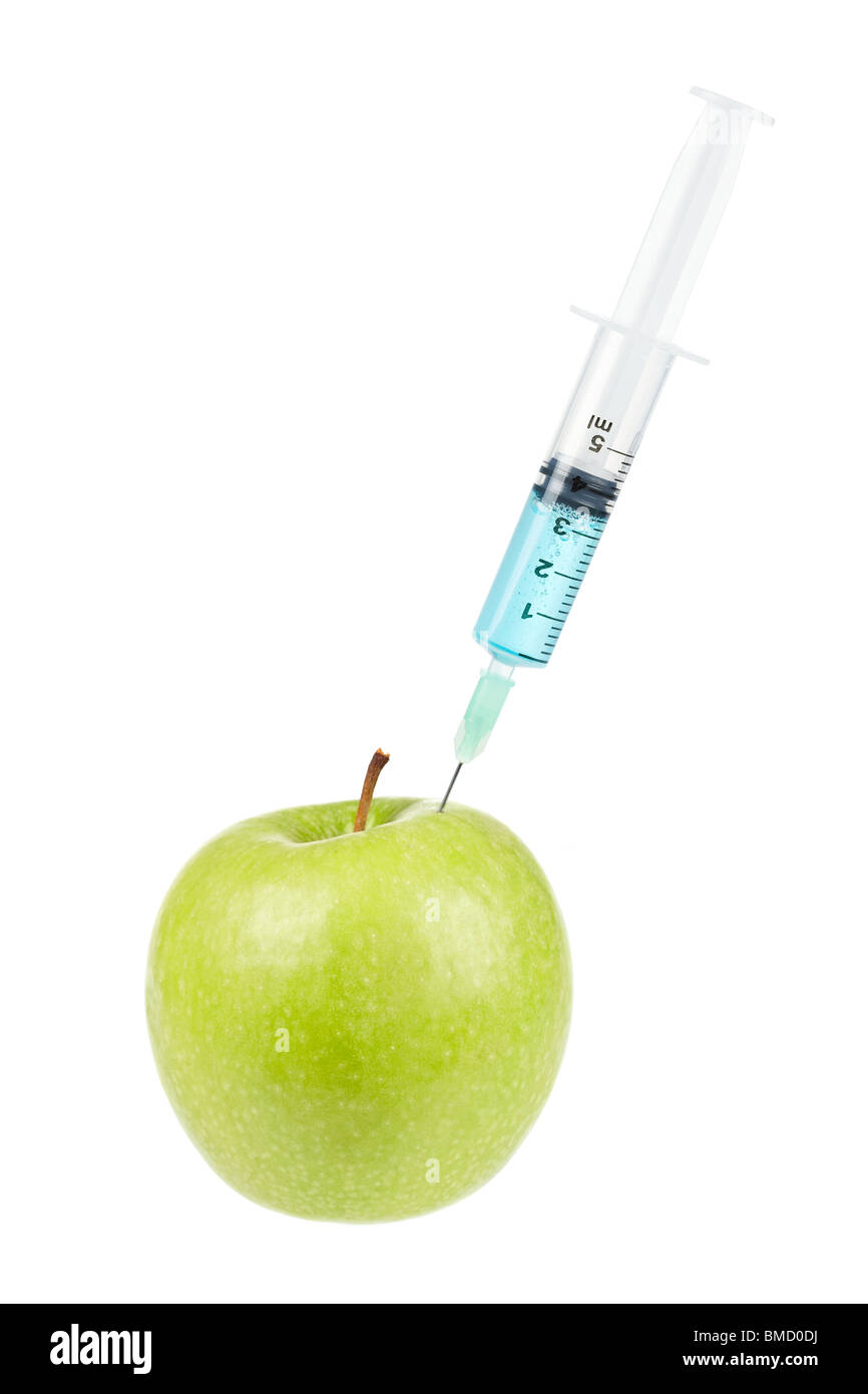 A green apple being injected with a syringe containing blue fluid ...