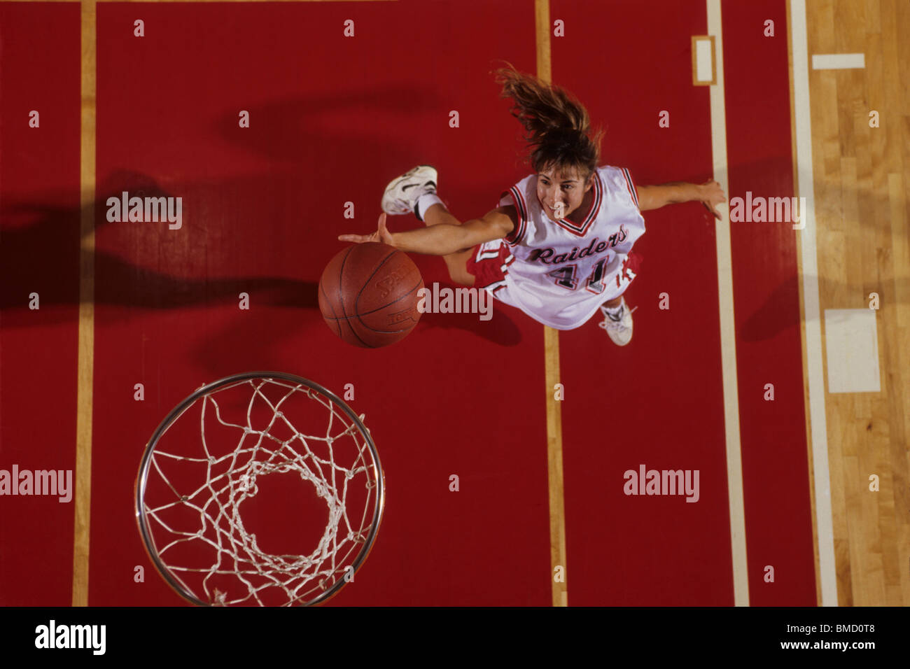 Female basketball player going up for a shot Stock Photo - Alamy