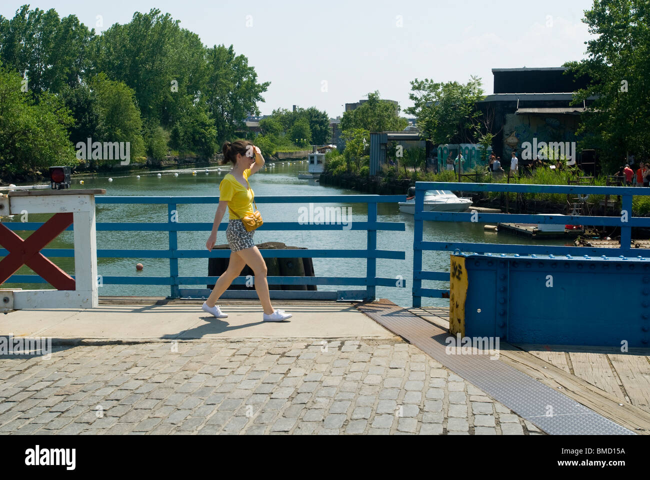 A woman crosses the Carroll Street Bridge over the Gowanus Canal in the ...