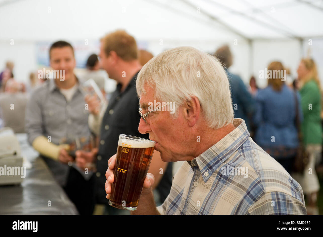 A customer drinking a pint of real ale at the Hoop Beer Festival in ...