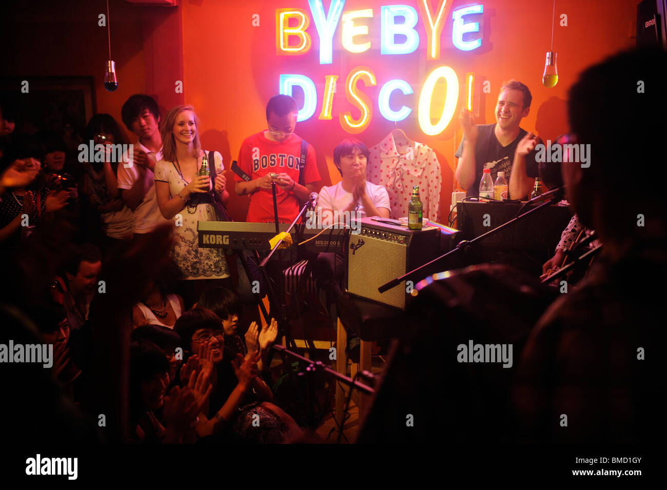 People listening folk music at a bar in Nan Luo Gu Xiang in Beijing ...