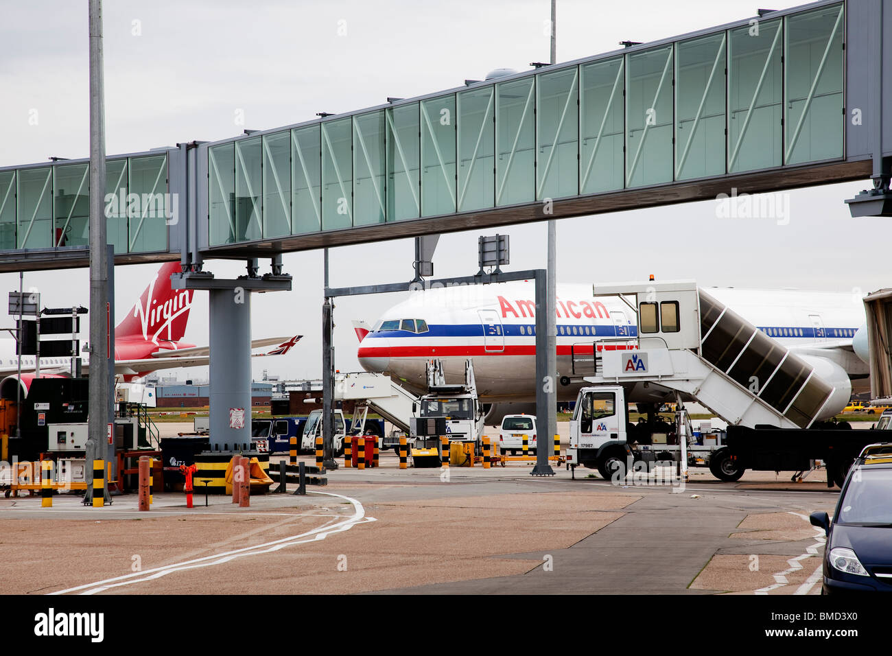 An American Airlines and Virgin Atlantic aircraft stand on the tarmac ...