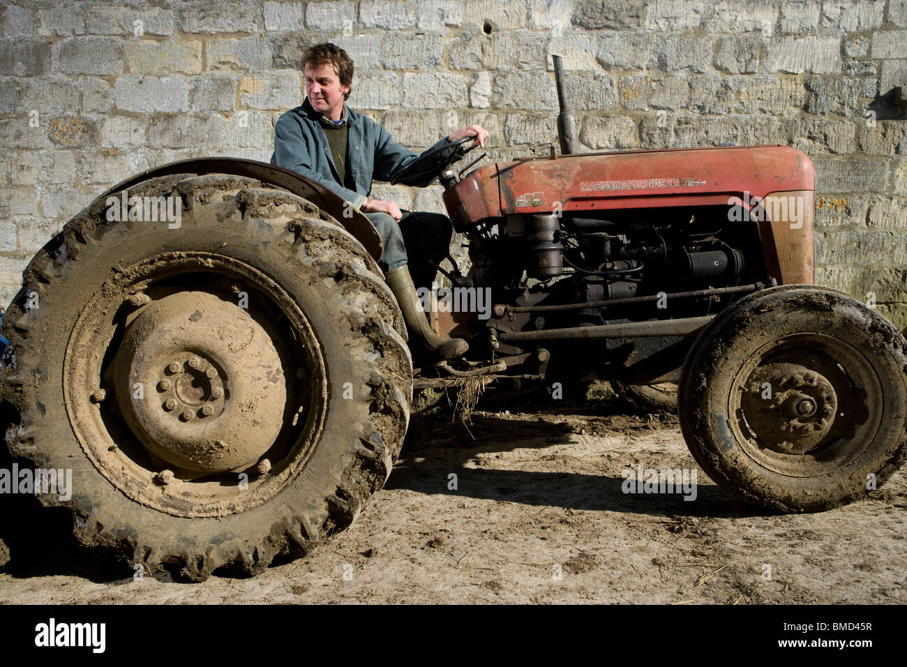 Farmer Jonathan Crump driving his tractor on Standish Park Farm ...