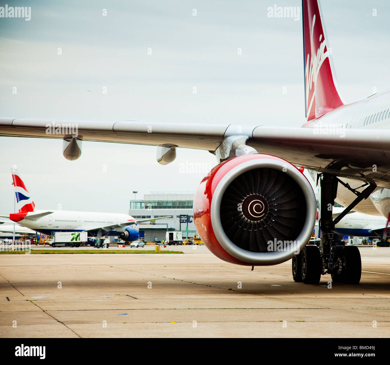 A Virgin Atlantic Airbus and a British Airways aircraft stand at gates ...