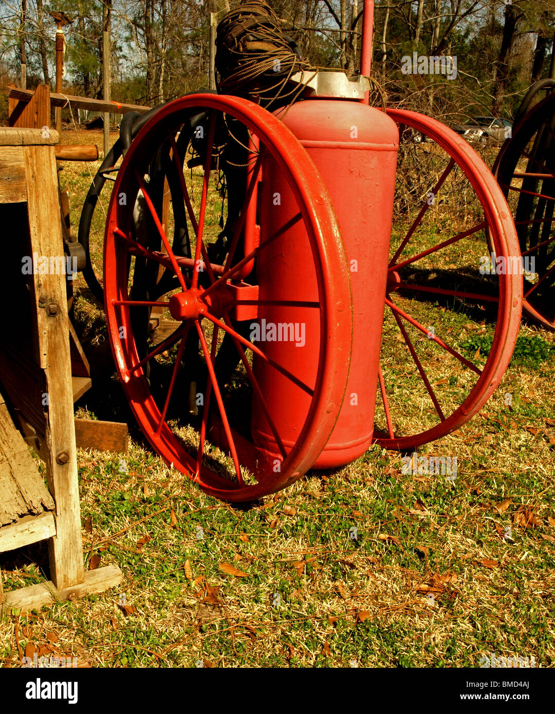 propane gas air compressor tank old red on large wheels sitting in a ...