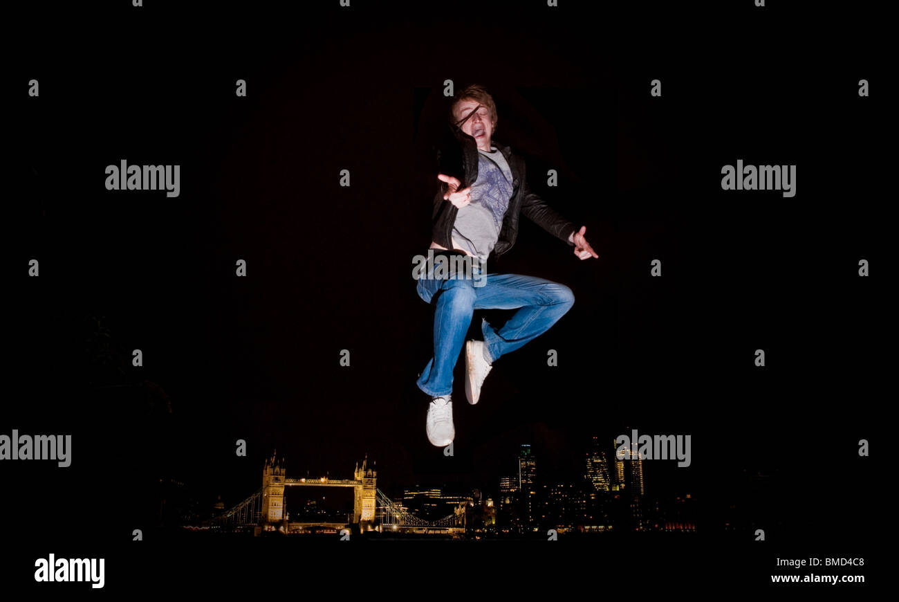 Man jumping over tower bridge Stock Photo - Alamy