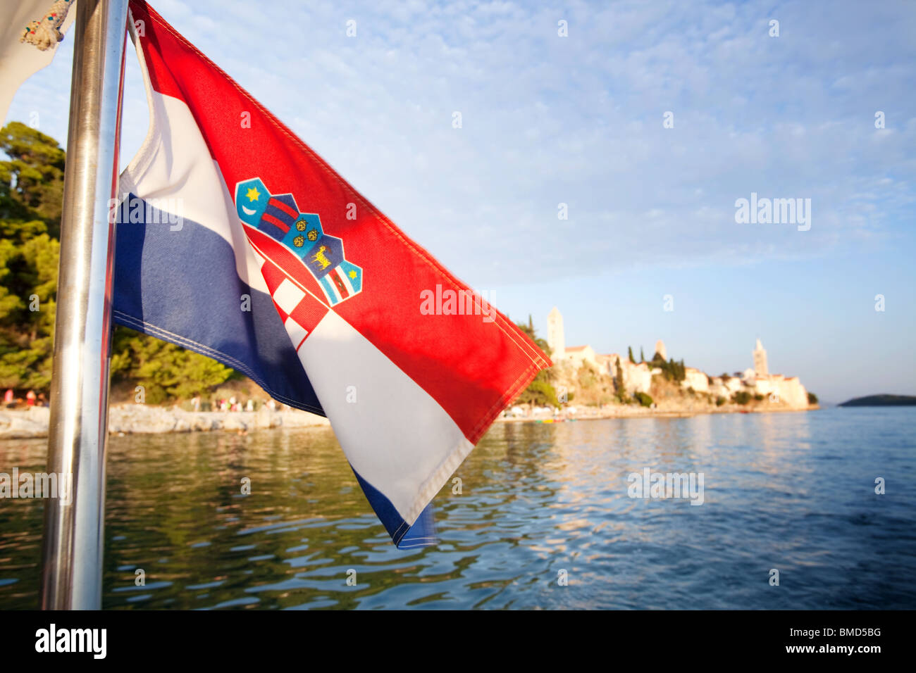 A croatian flag in front of a landscape of the island of Rab Stock ...