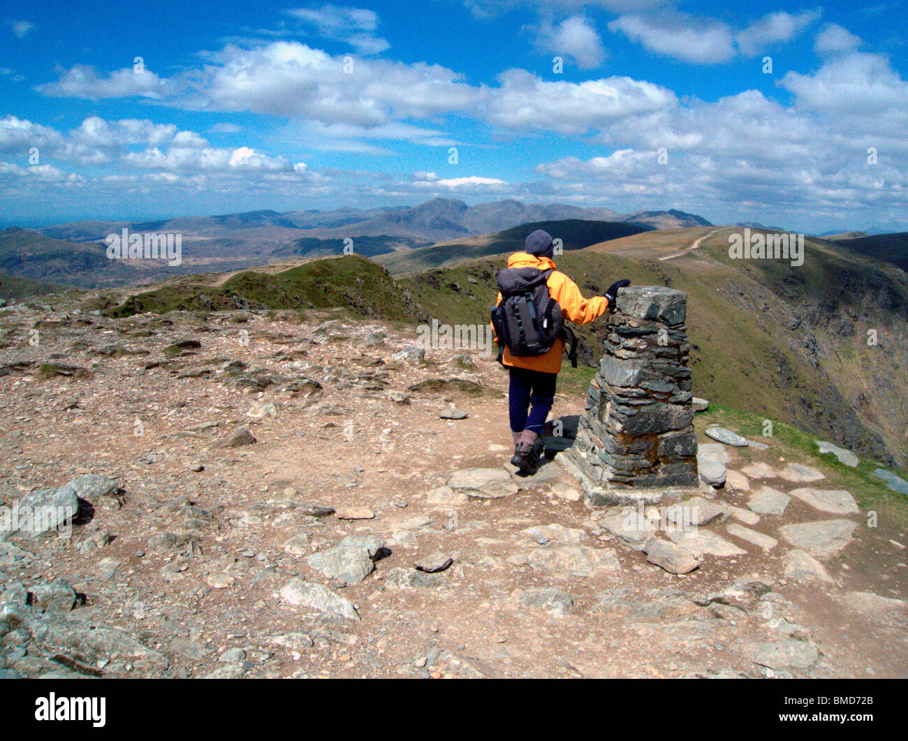 Walker looking north at trig point (803m) The Old Man of Coniston, Lake ...