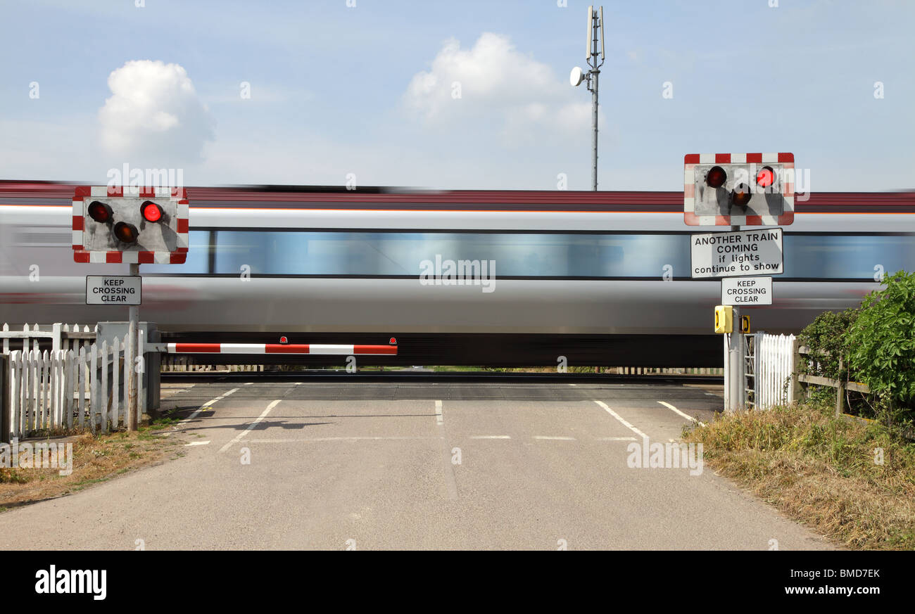 TRAIN AT SPEED OVER ROAD/RAIL CROSSING Stock Photo - Alamy