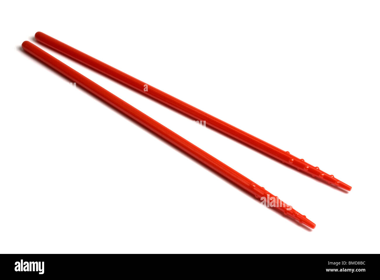 Red chopsticks isolated on white background Stock Photo - Alamy