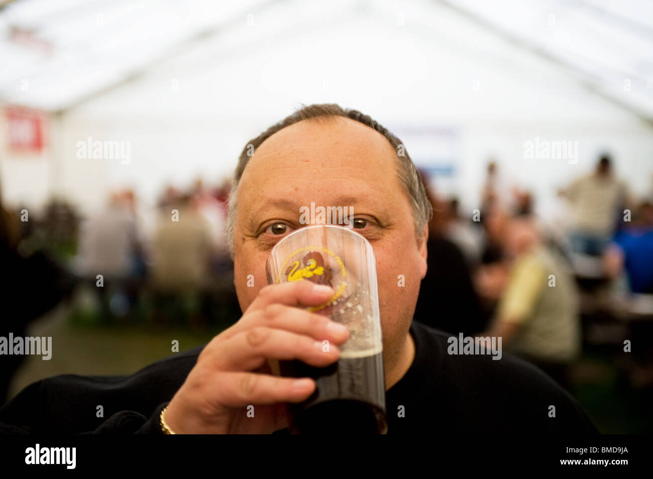 A customer drinking a pint of real ale at the Hoop Beer Festival in ...