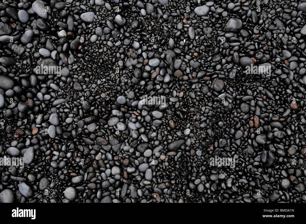 Volcanic black sand showing texture of pebbles and sand eroded by the ...