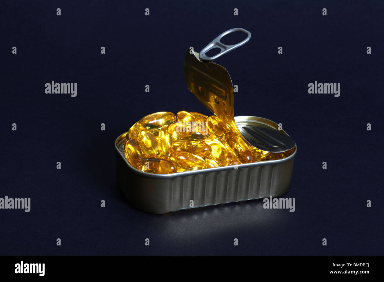 Fish Oil Capsules in an open Sardine Can Stock Photo - Alamy